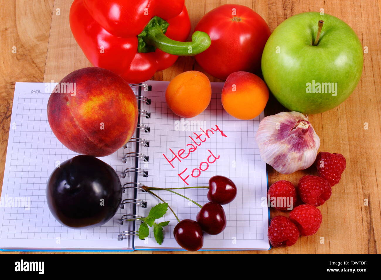 Fresh fruits and vegetables with notebook for writing notes, concept of ...