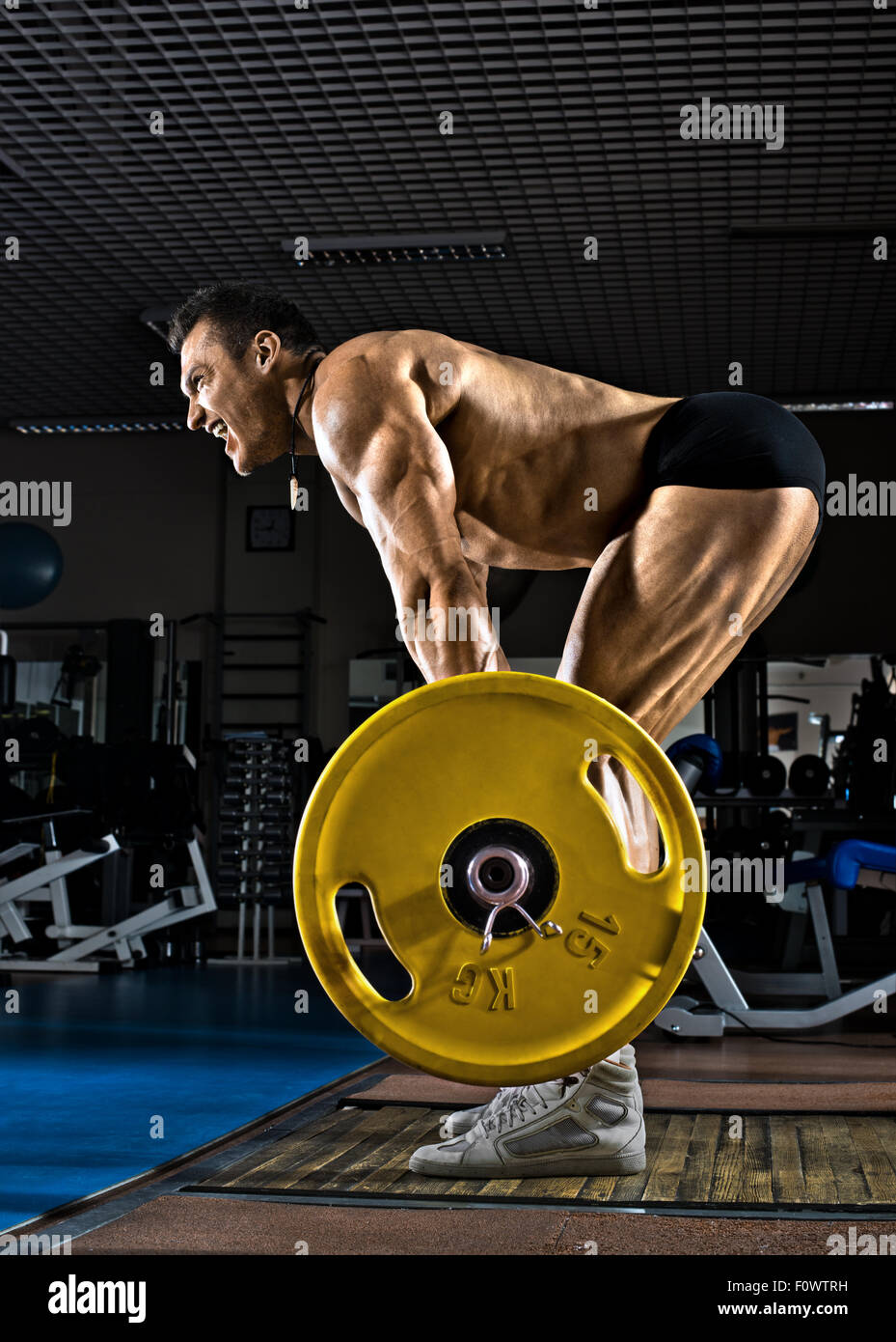 very brawny guy bodybuilder , execute exercise deadlift with weight, in ...