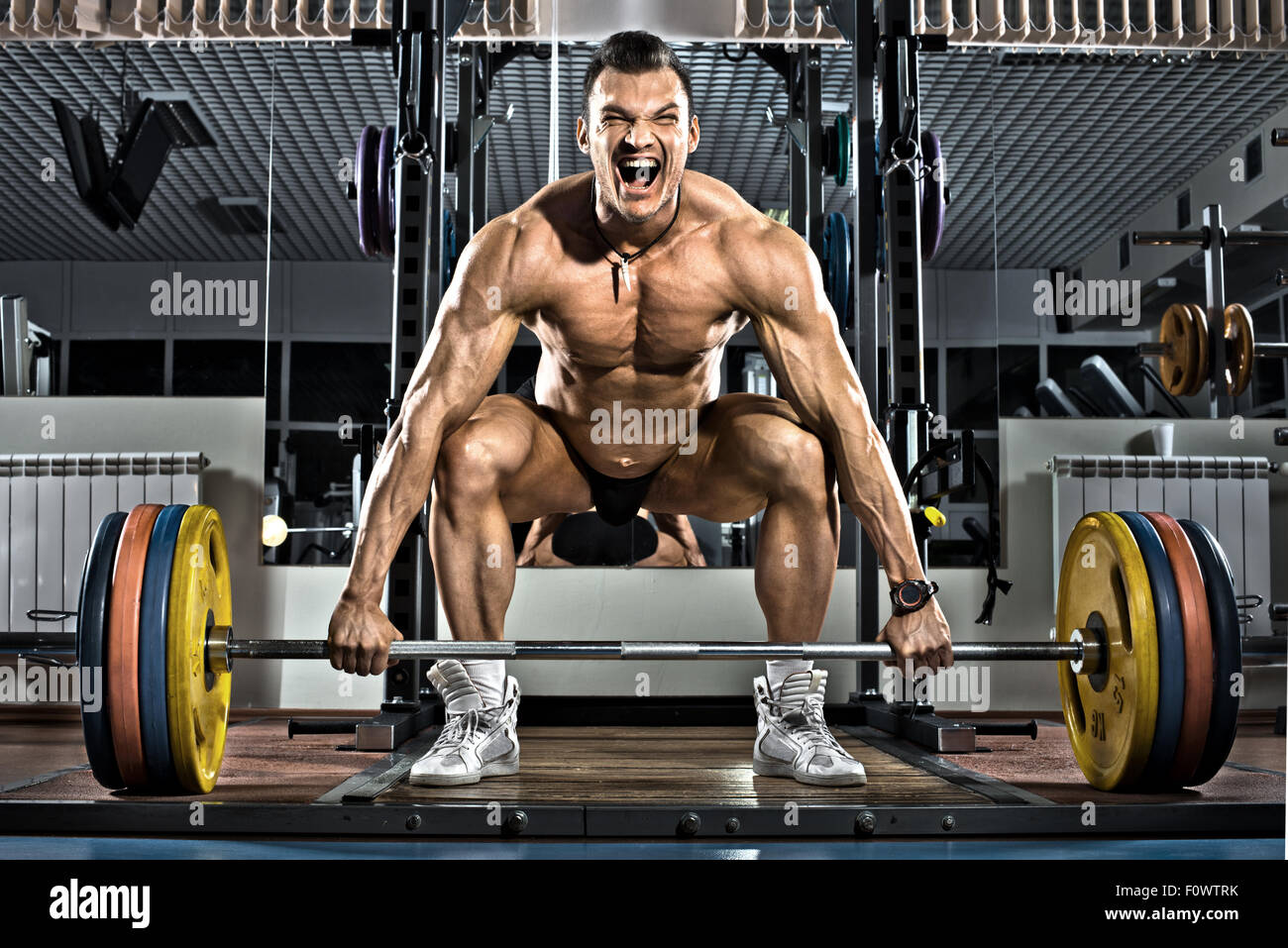 very brawny guy bodybuilder , execute exercise deadlift with weight, in ...