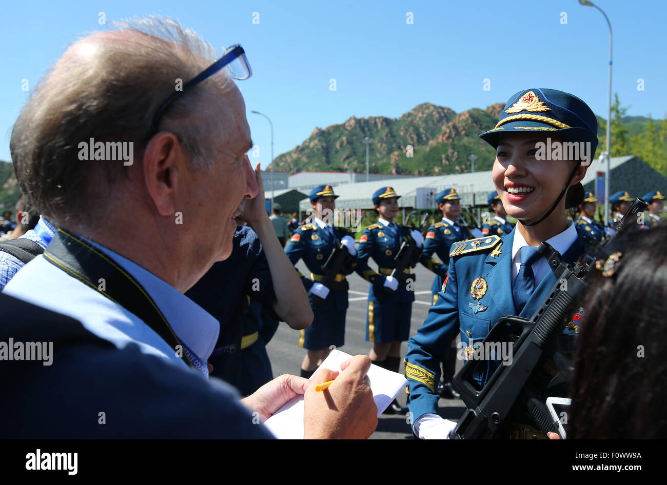 Beijing, China. 22nd Aug, 2015. A soldier is interviewed at the parade ...