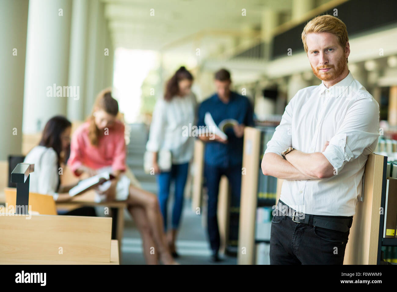 Young man in the library Stock Photo - Alamy