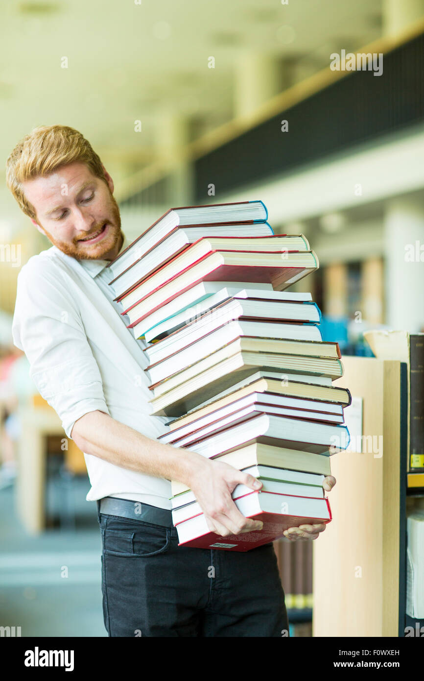 Young man in the library Stock Photo - Alamy