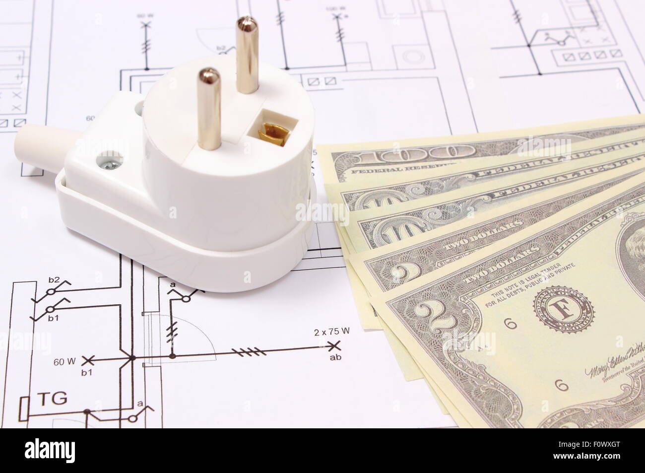 Electric plug and money on electrical construction drawing of house ...