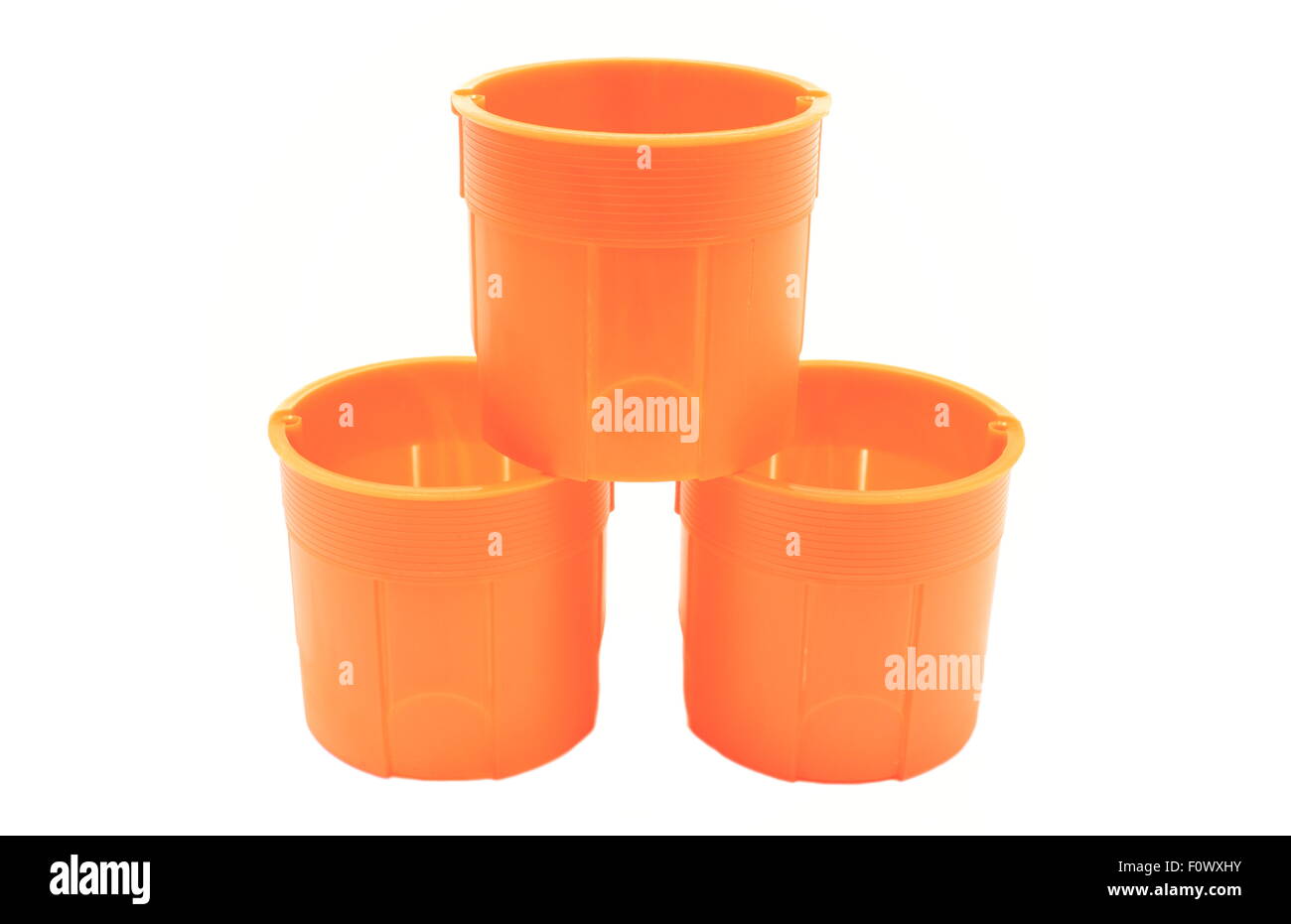 Stack of orange plastic electrical boxes on white background, junction ...