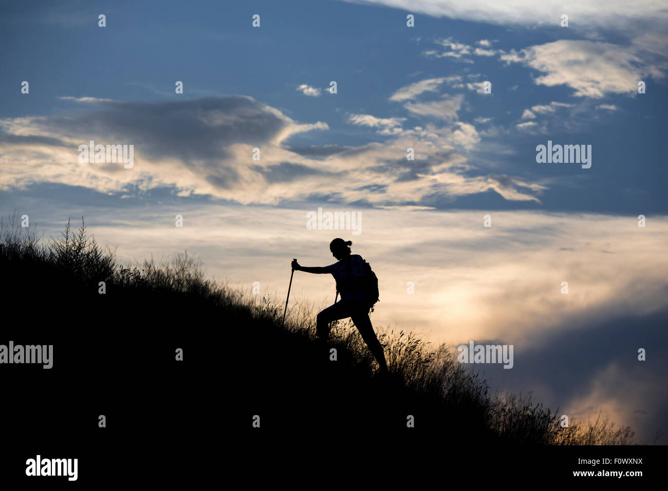 Mountain hiker in front of sunset Stock Photo - Alamy