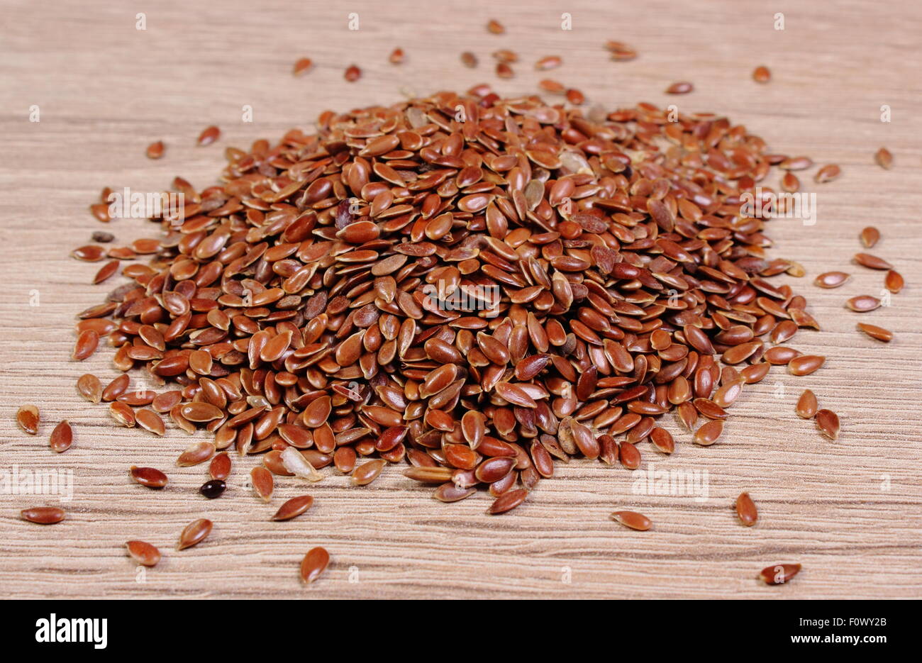 Heap of brown linseed, flax seeds on wooden background, concept for healthy nutrition Stock ...