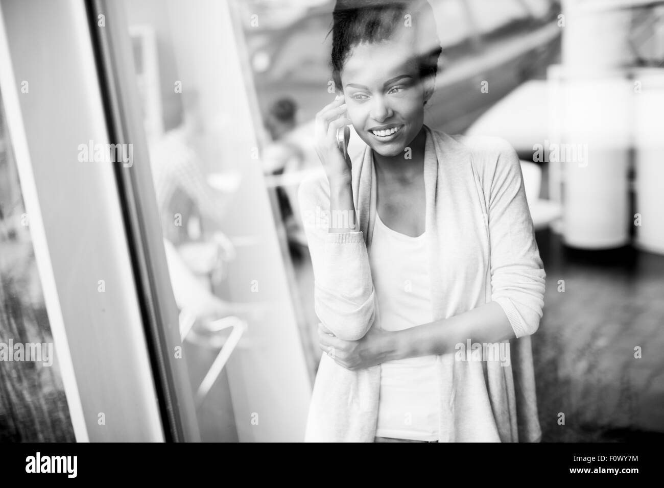 Woman young window standing Black and White Stock Photos & Images - Alamy