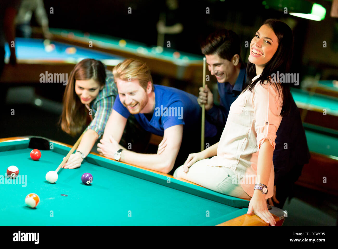 Young people playing pool Stock Photo - Alamy