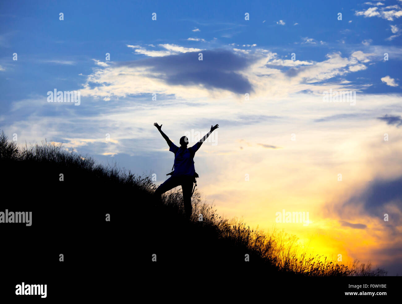 Silhouette of woman with raised hands Stock Photo - Alamy