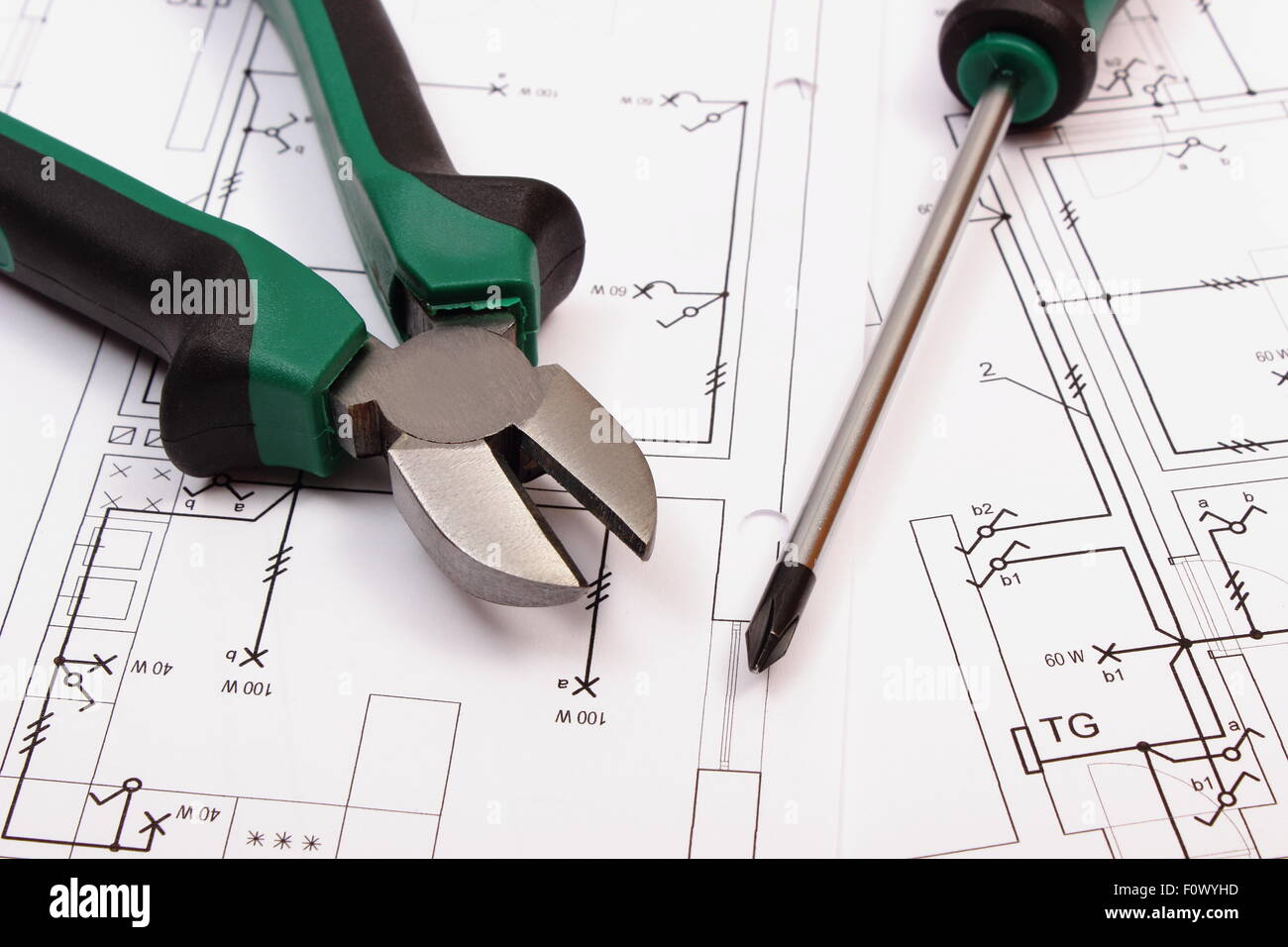 Metal pliers and screwdriver on electrical construction drawing of ...