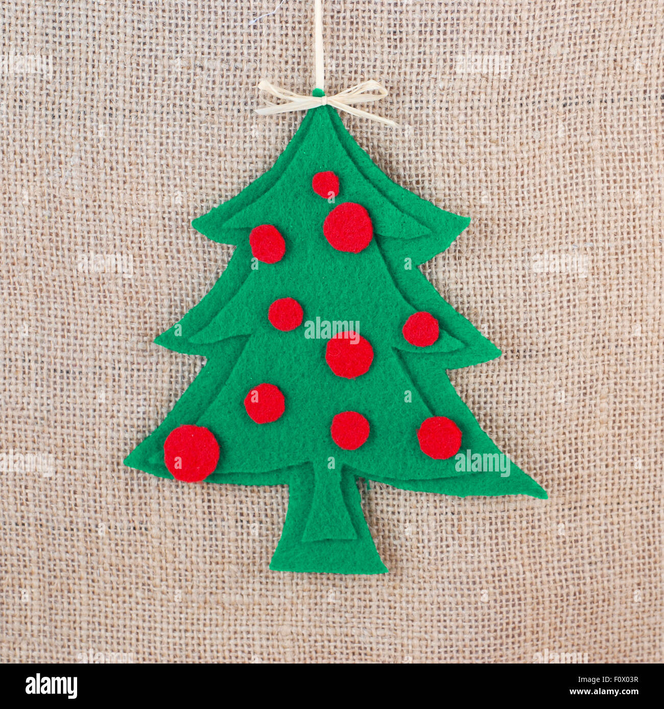 Rustic Christmas image with Christmas tree cut out of felt on burlap ...