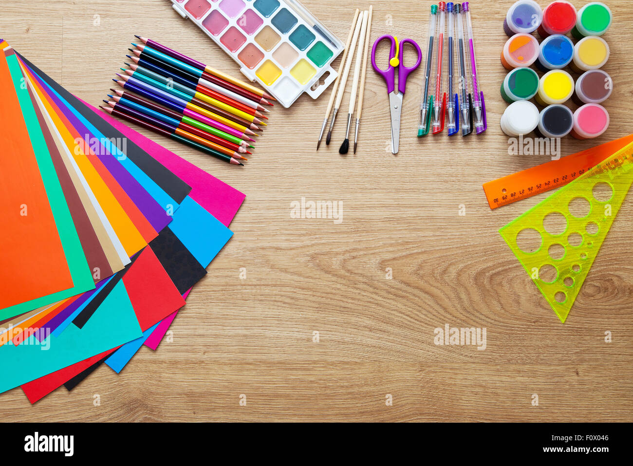 set of school supplies with pencils, paint, pens, paper, scissors and ...