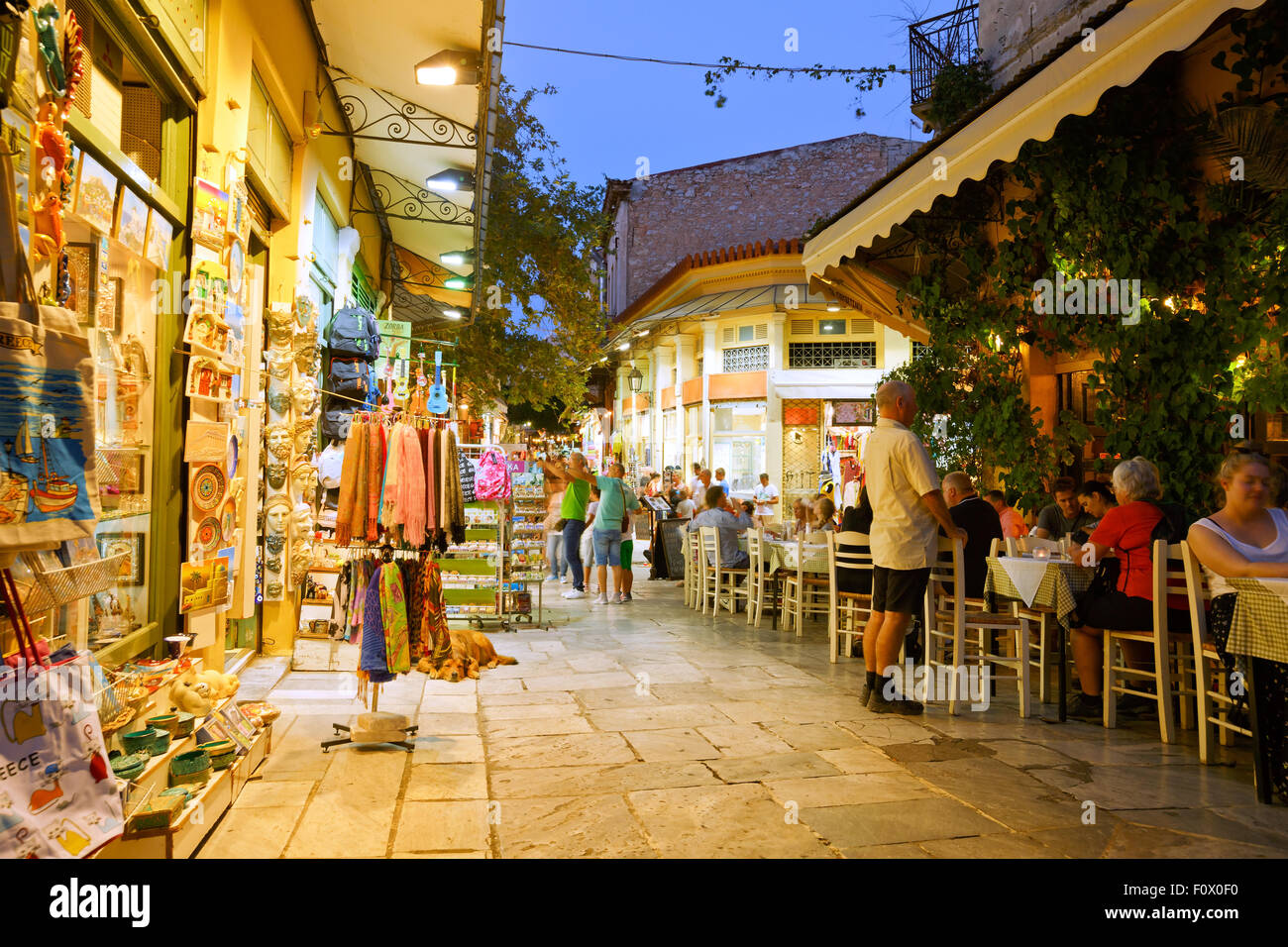 Tourists in a street in the old town of plaka with shops and ...