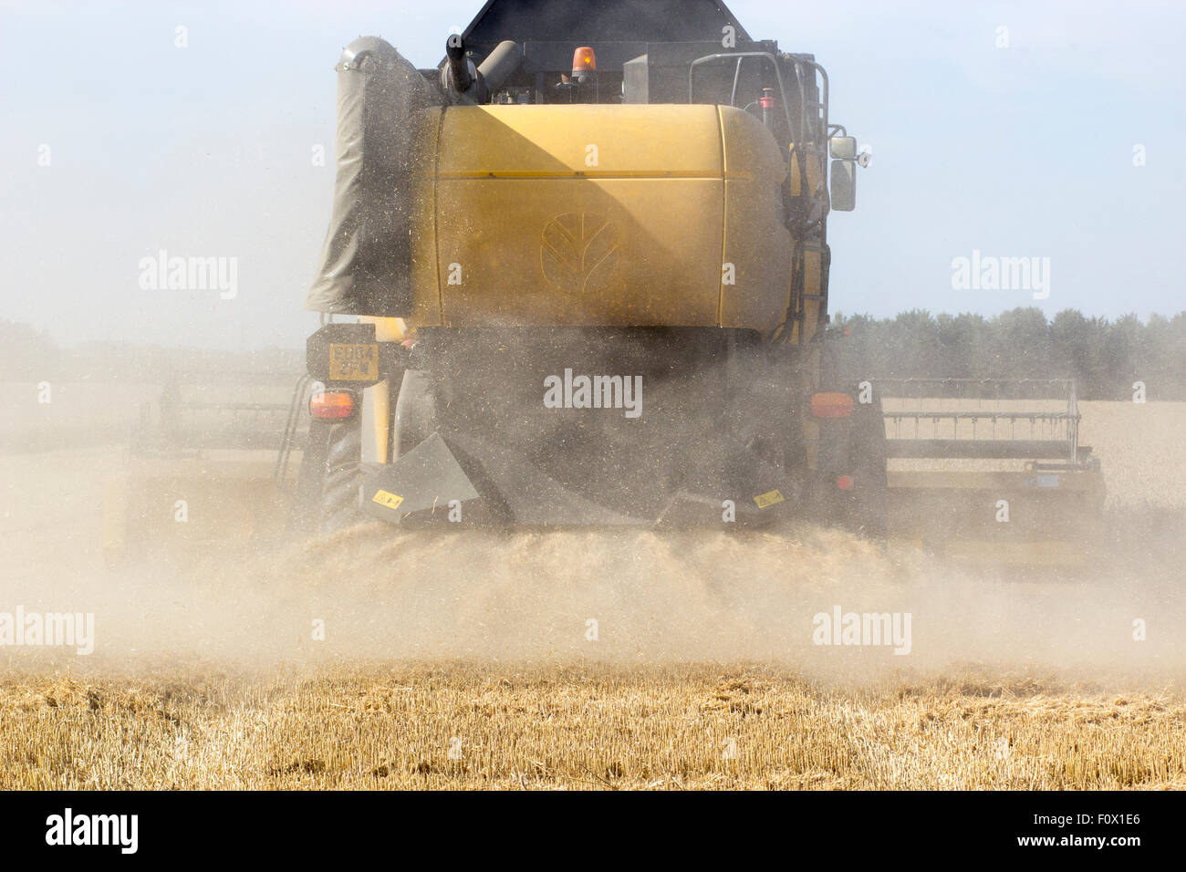 Combine harvester throwing out dust Stock Photo - Alamy