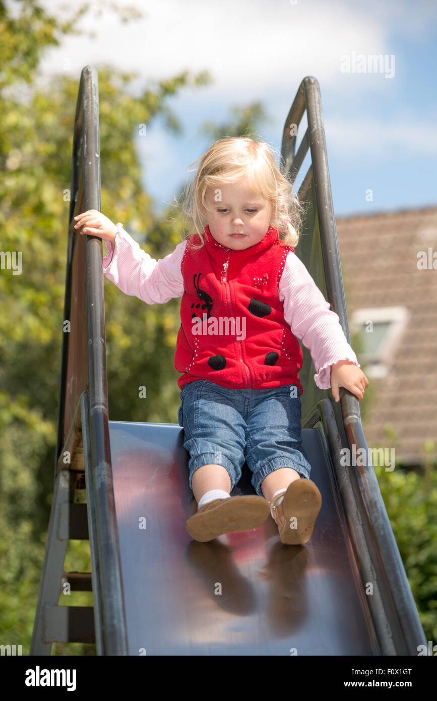 Little girl on slide Stock Photo - Alamy