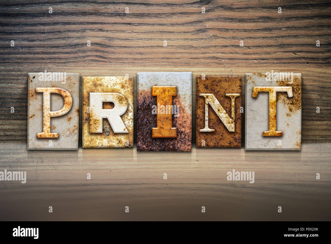 The word "PRINT" written in rusty metal letterpress type sitting on a ...