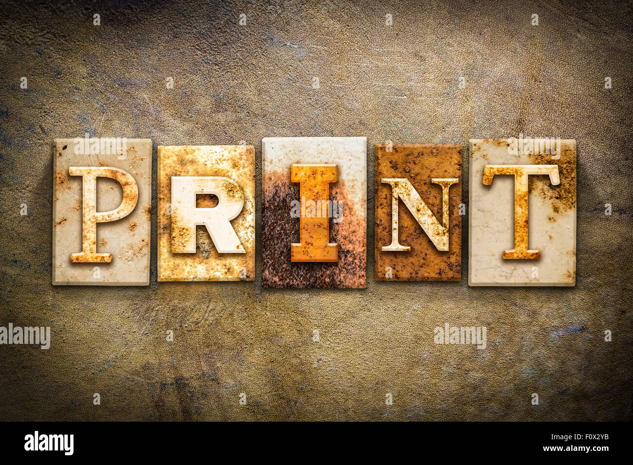 The word "PRINT" written in rusty metal letterpress type on an old aged ...