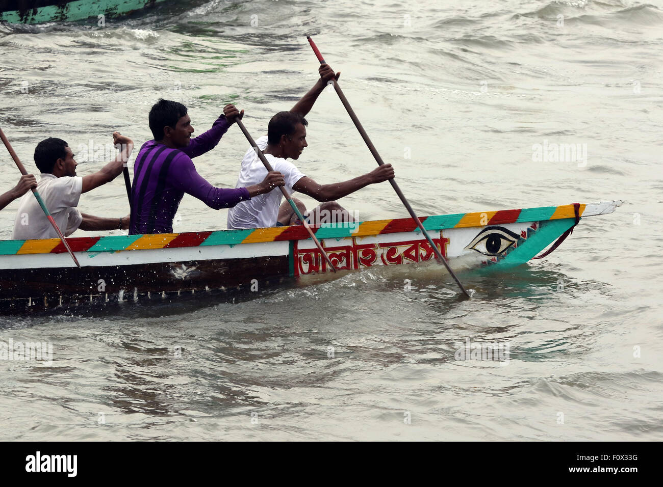 Bangladeshi men row a boat during a traditional boat race on the ...