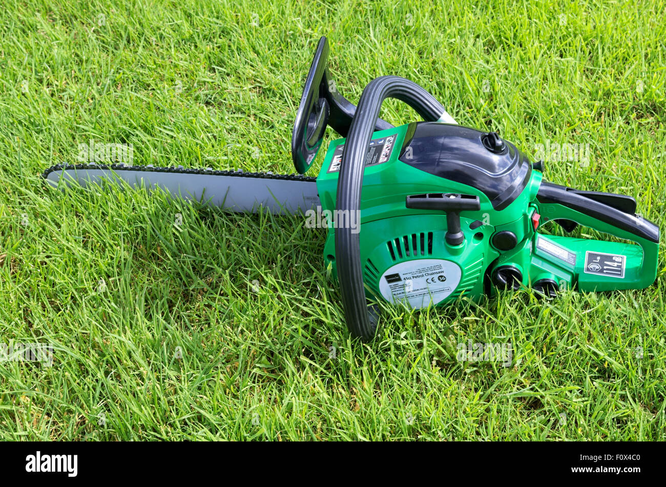 New chainsaw on grass background Stock Photo - Alamy
