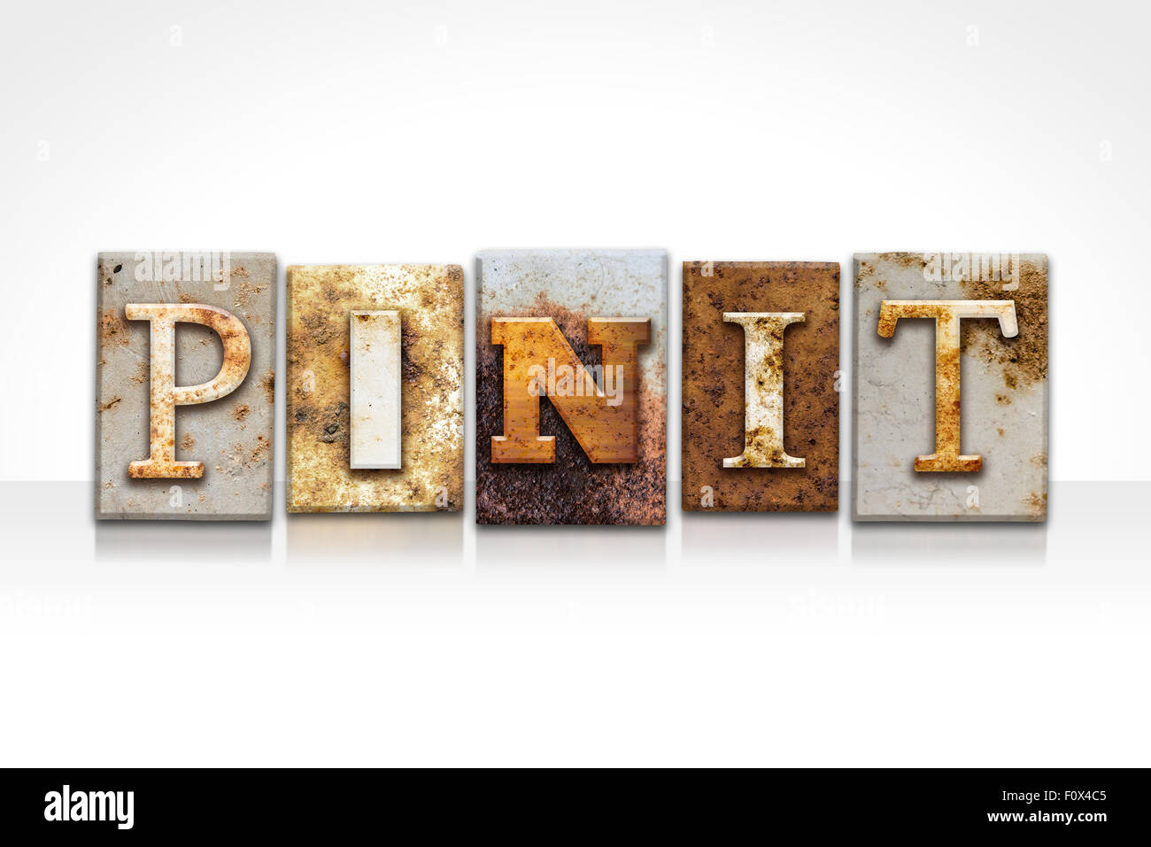 The word "PIN IT" written in rusty metal letterpress type isolated on a ...