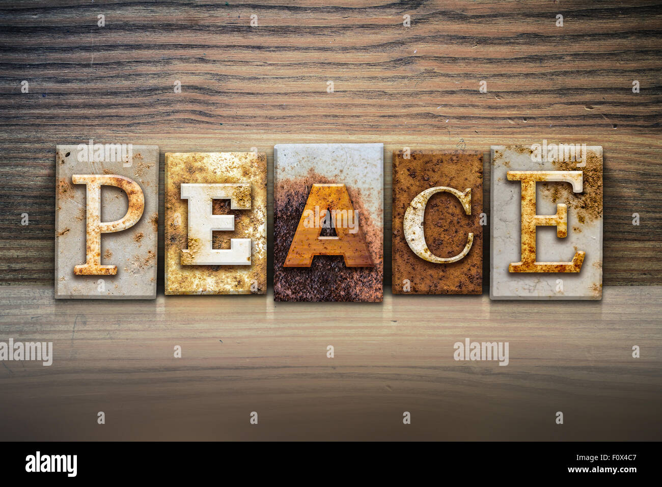 The word "PEACE" written in rusty metal letterpress type sitting on a ...