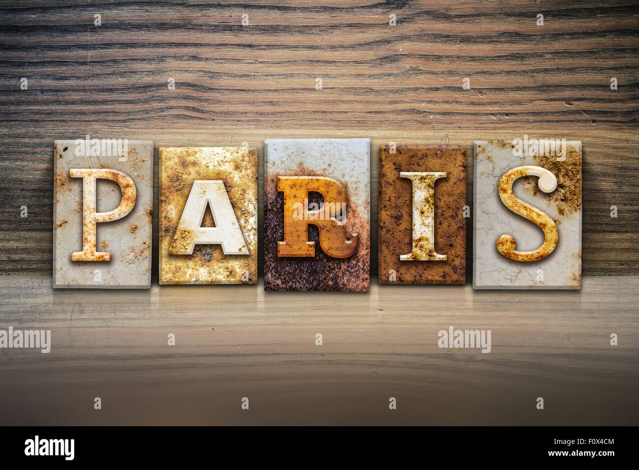 The word "PARIS" written in rusty metal letterpress type sitting on a ...
