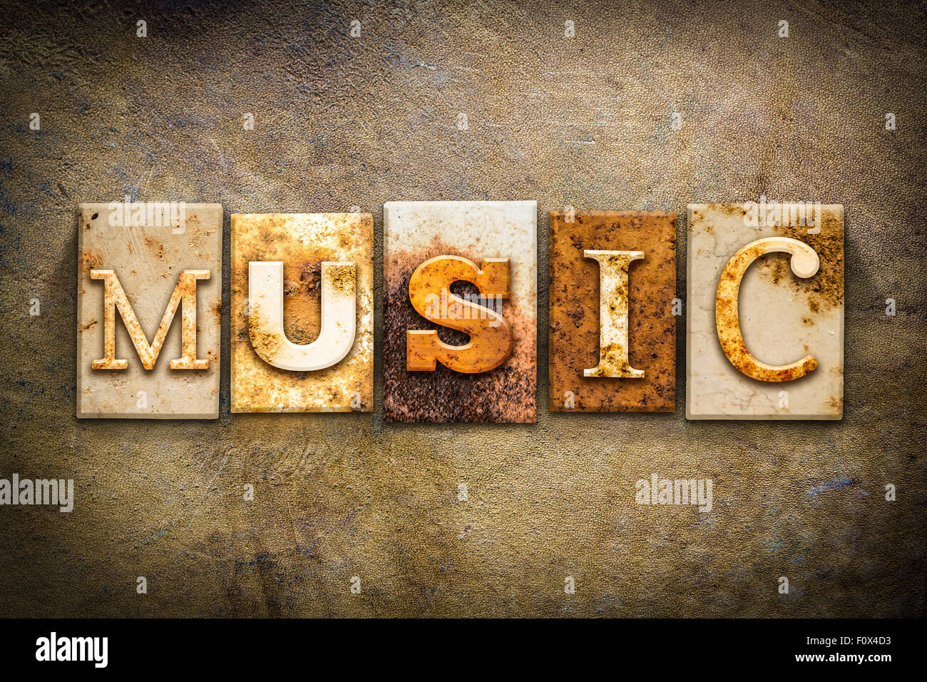 The word "MUSIC" written in rusty metal letterpress type on an old aged ...