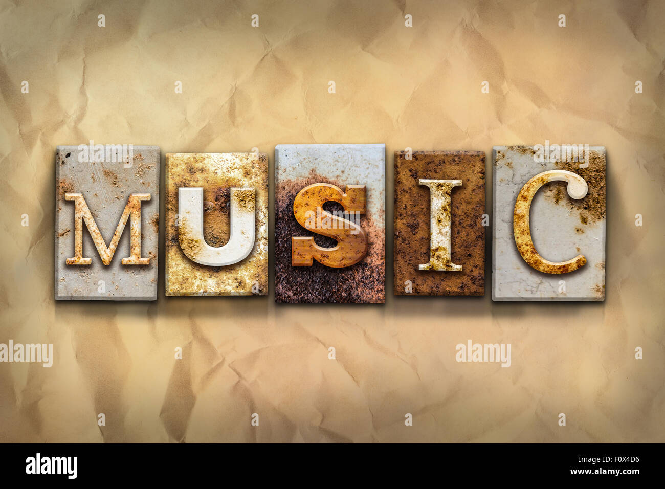 The word "MUSIC" written in rusty metal letterpress type on a crumbled ...