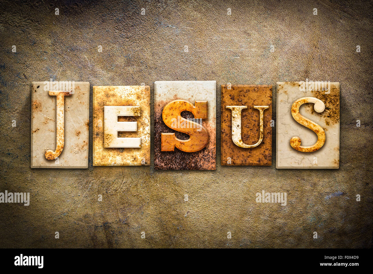 The name "JESUS" written in rusty metal letterpress type on an old aged ...