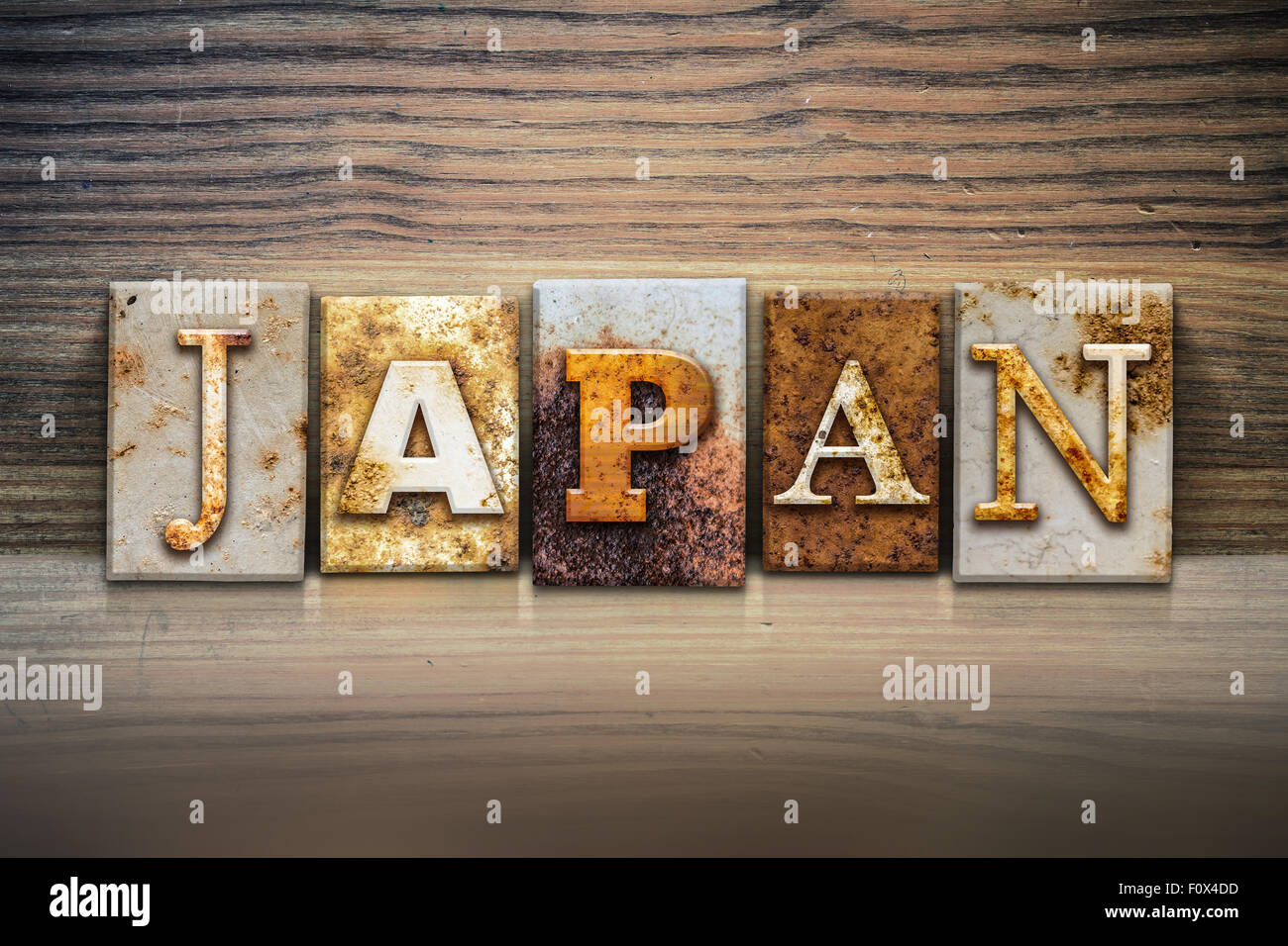 The word "JAPAN" written in rusty metal letterpress type sitting on a ...