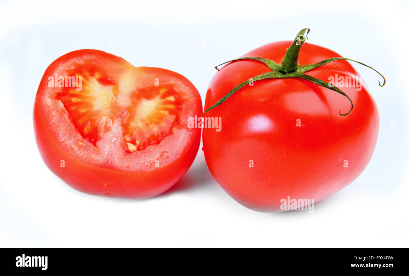 Tomato and half cross isolated on white Stock Photo - Alamy