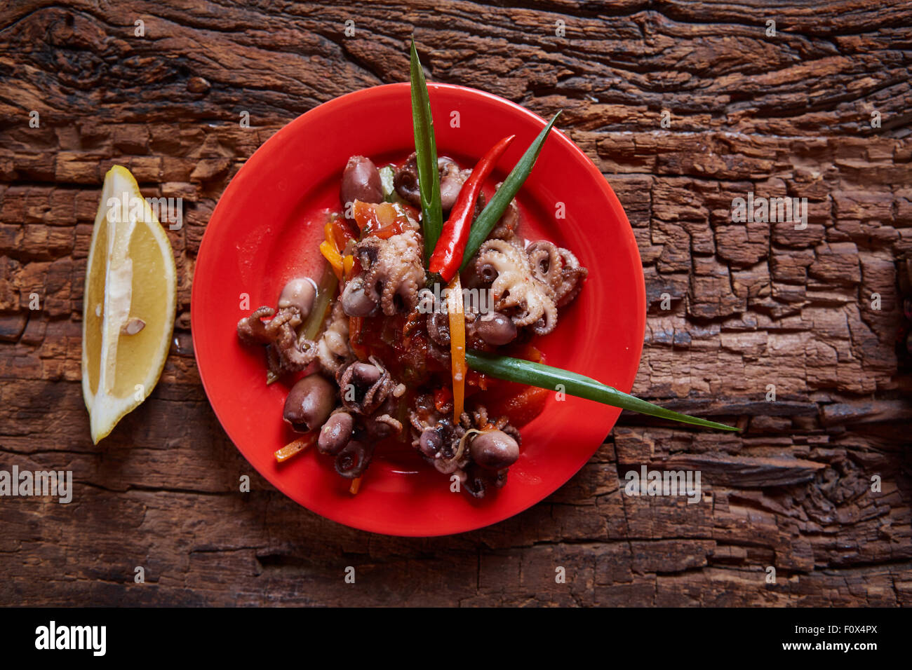 Baby octopuses in red dish Stock Photo - Alamy