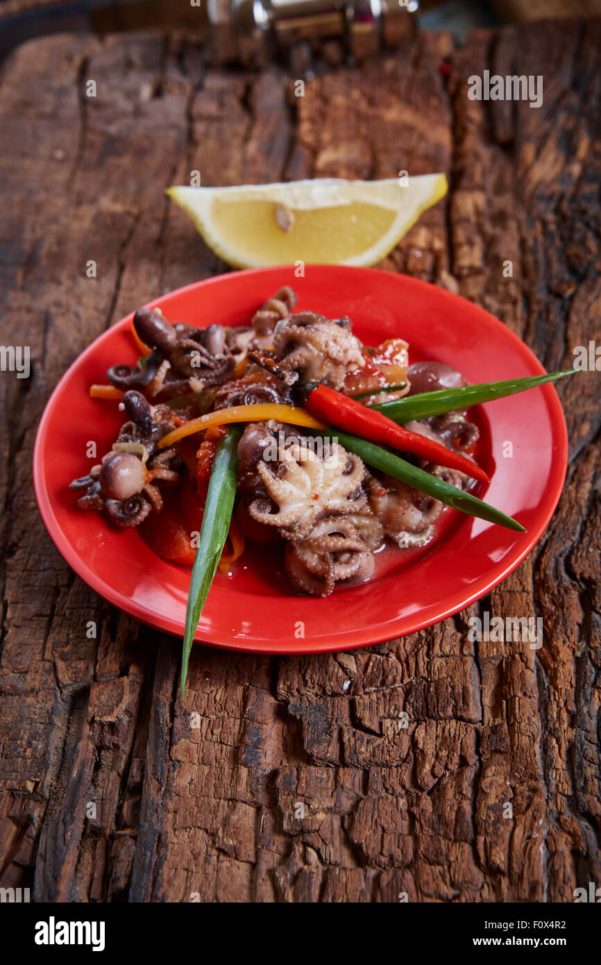 Baby octopuses in red dish Stock Photo - Alamy
