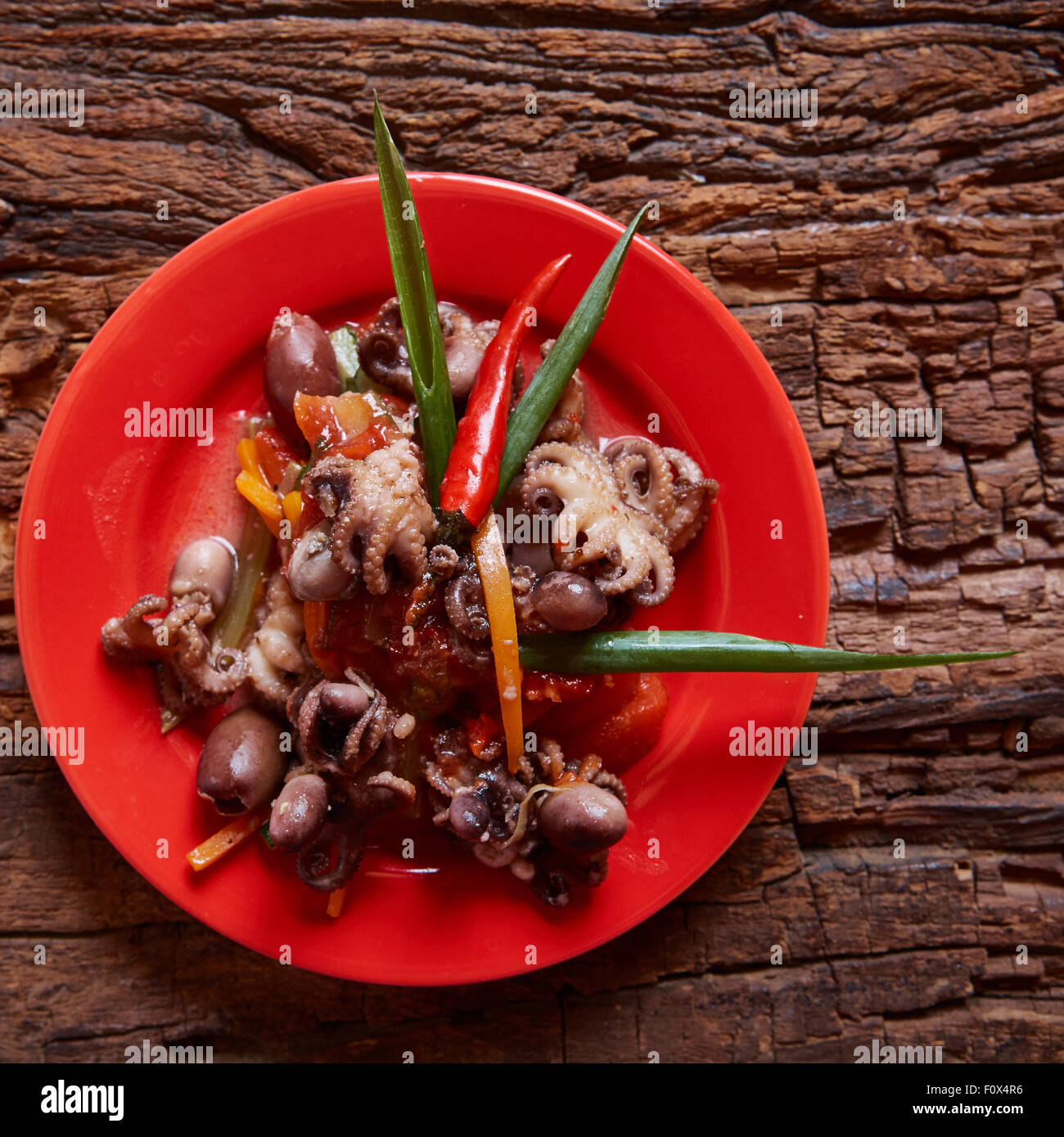 Baby octopuses in red dish Stock Photo - Alamy