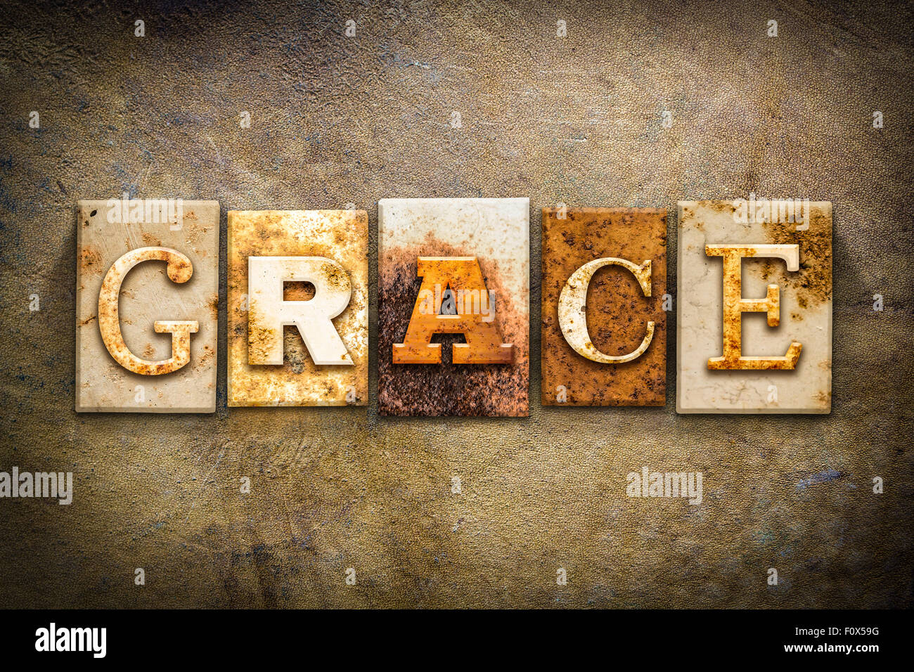 The word "GRACE" written in rusty metal letterpress type on an old aged ...