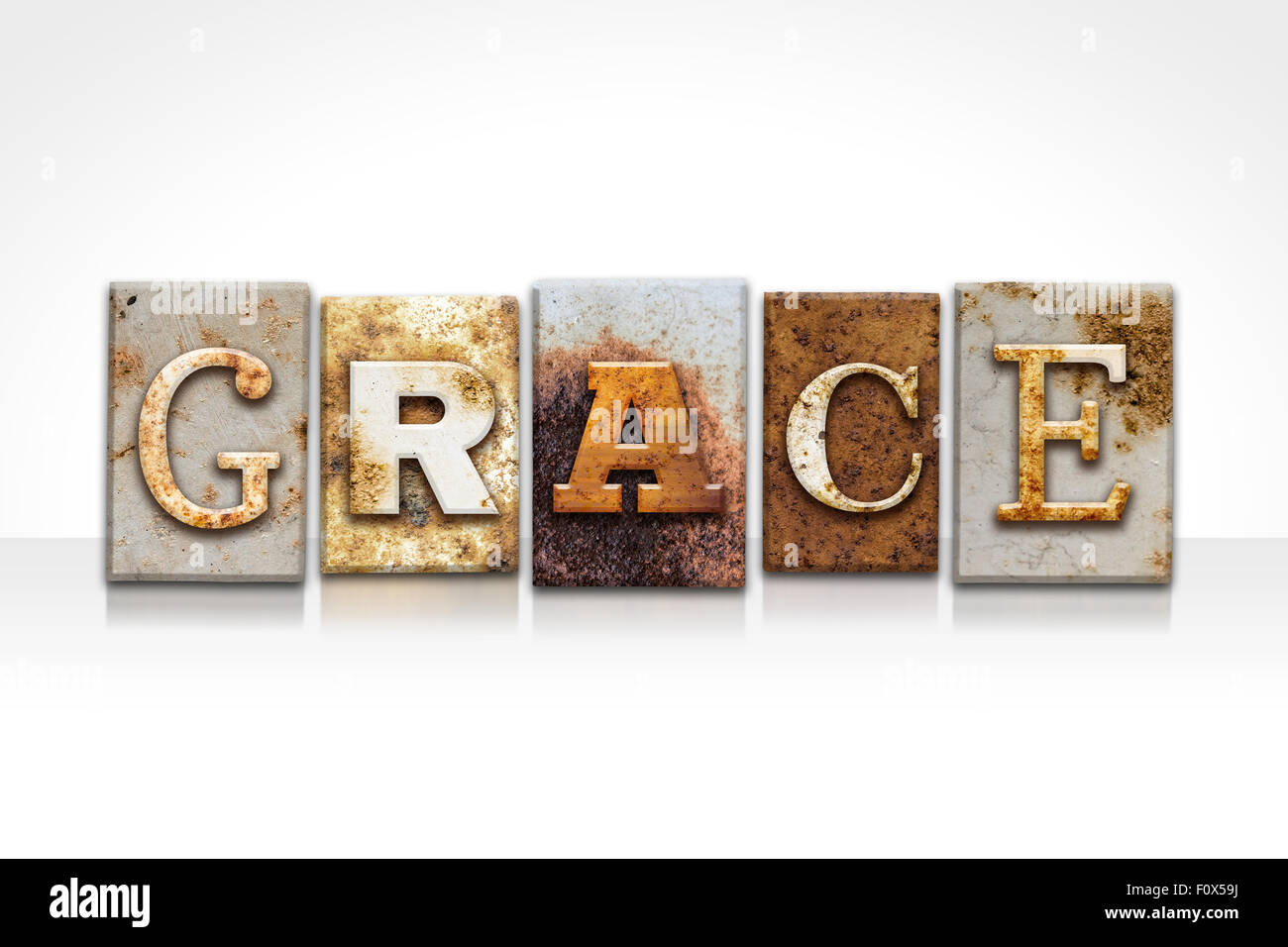 The word "GRACE" written in rusty metal letterpress type isolated on a ...