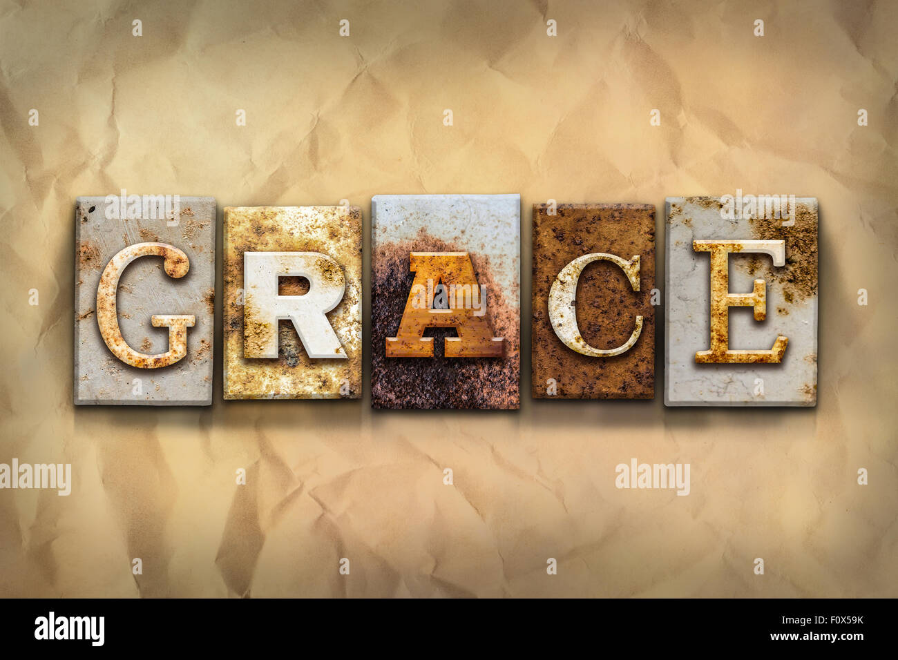 The word "GRACE" written in rusty metal letterpress type on a crumbled ...