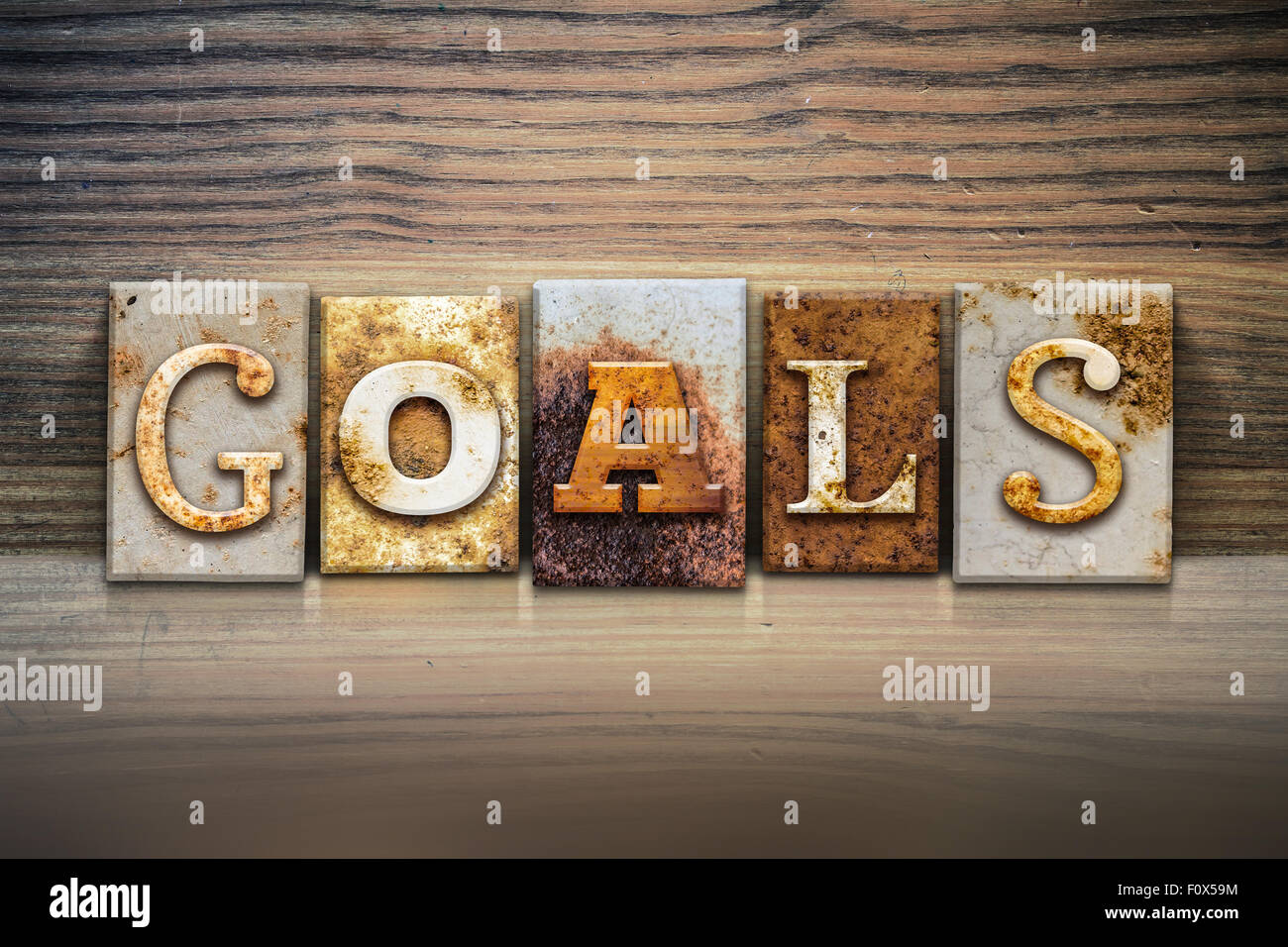 The word "GOALS" written in rusty metal letterpress type sitting on a ...