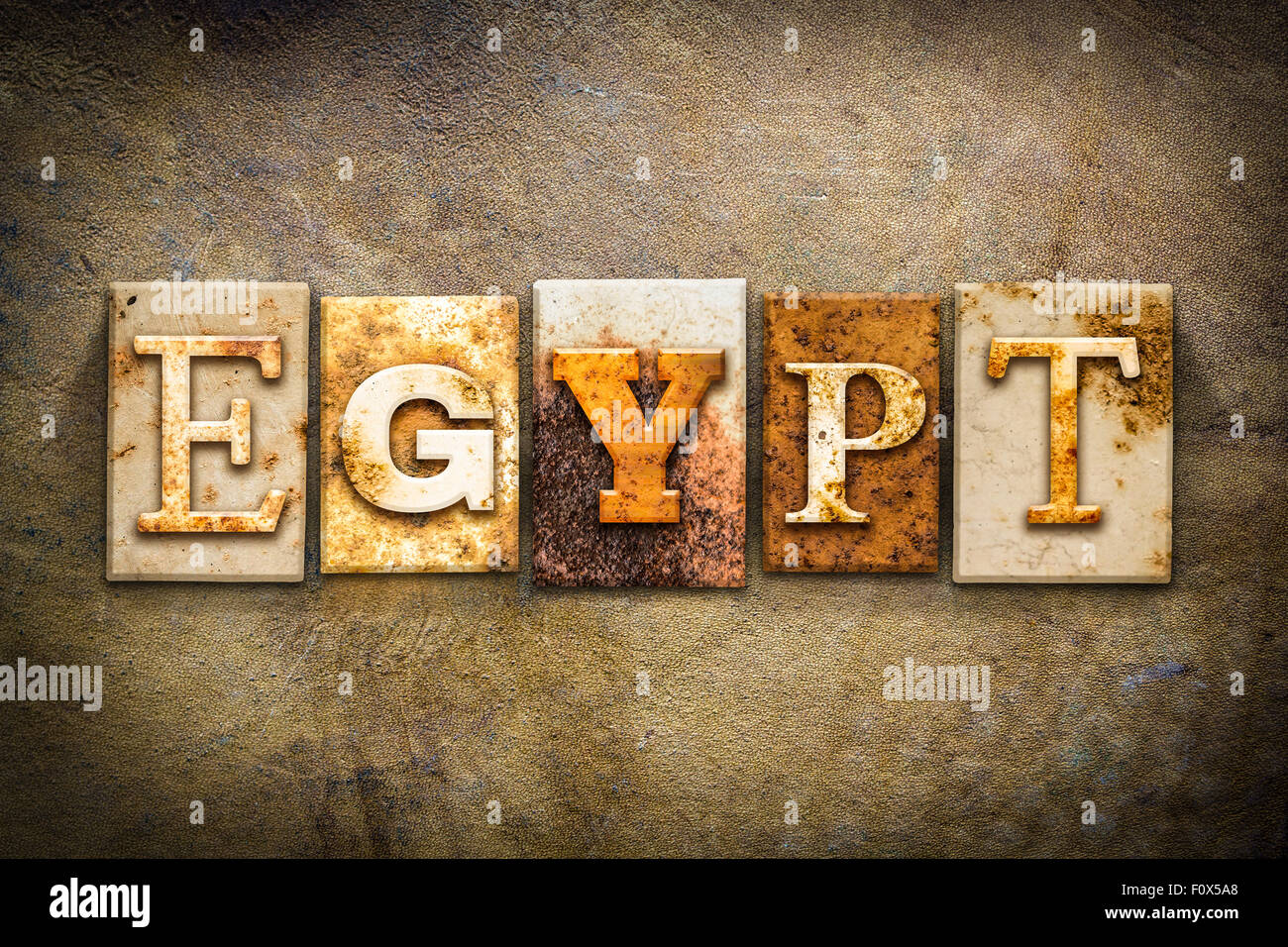The word "EGYPT" written in rusty metal letterpress type on an old aged ...