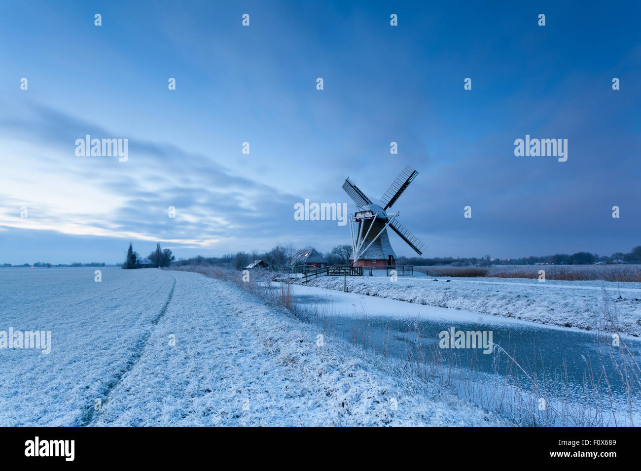 windmill by frozen river in winter, Netherlands Stock Photo - Alamy