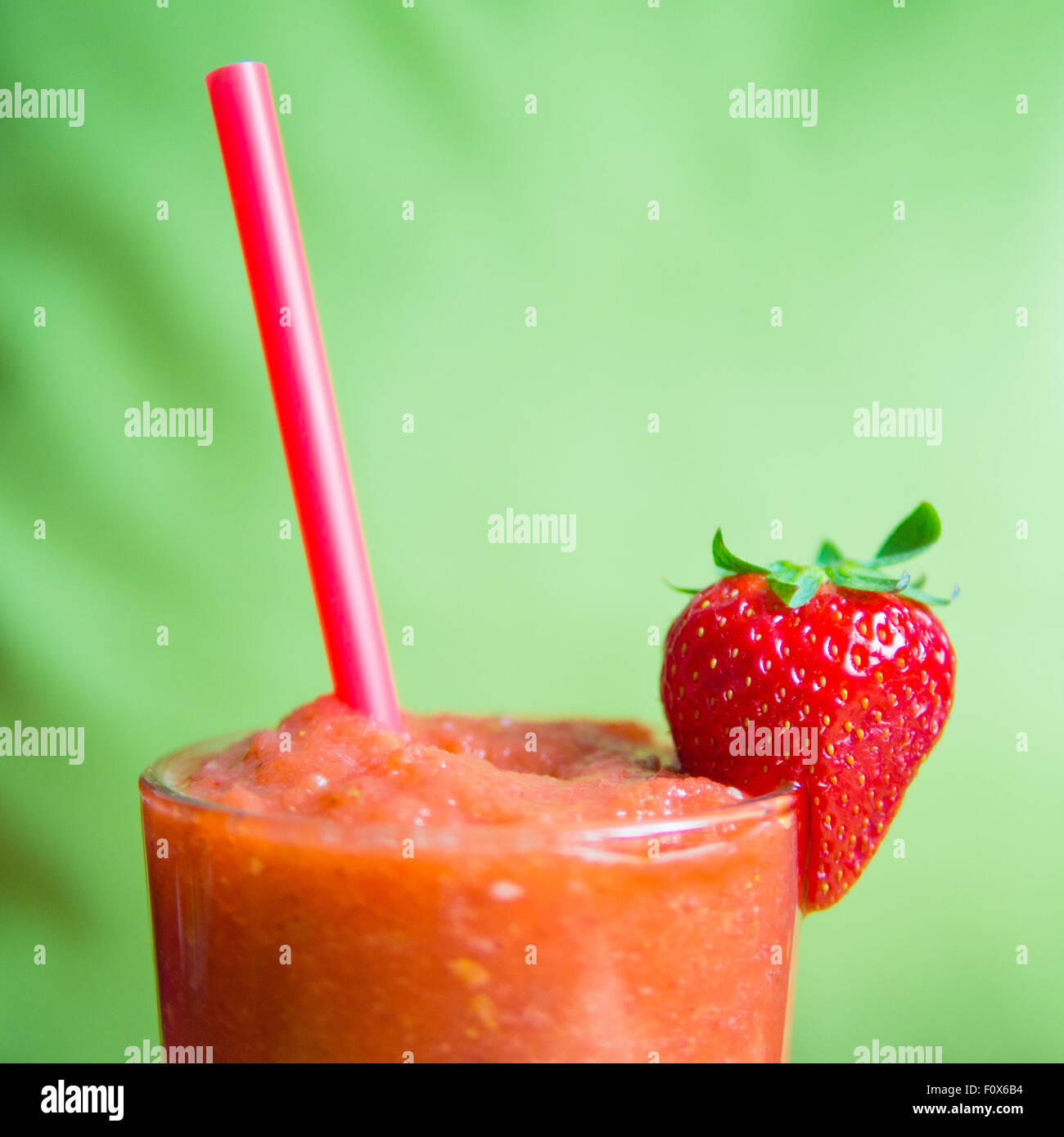 Strawberry smoothie in glass with straw Stock Photo - Alamy