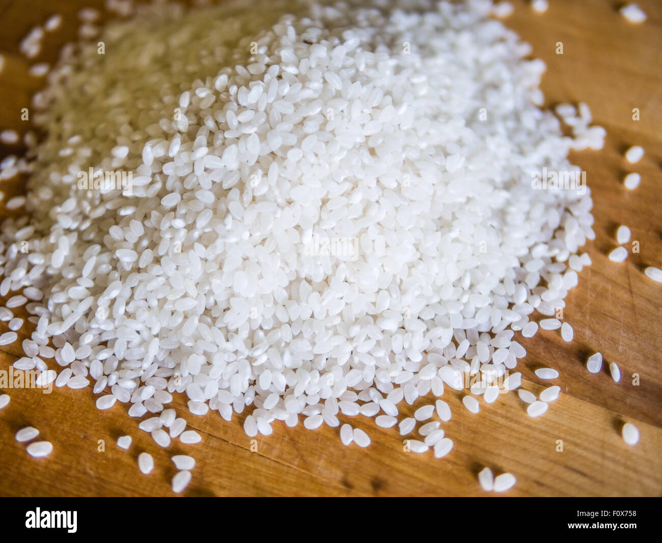 Pile of white rice on the wooden board Stock Photo - Alamy