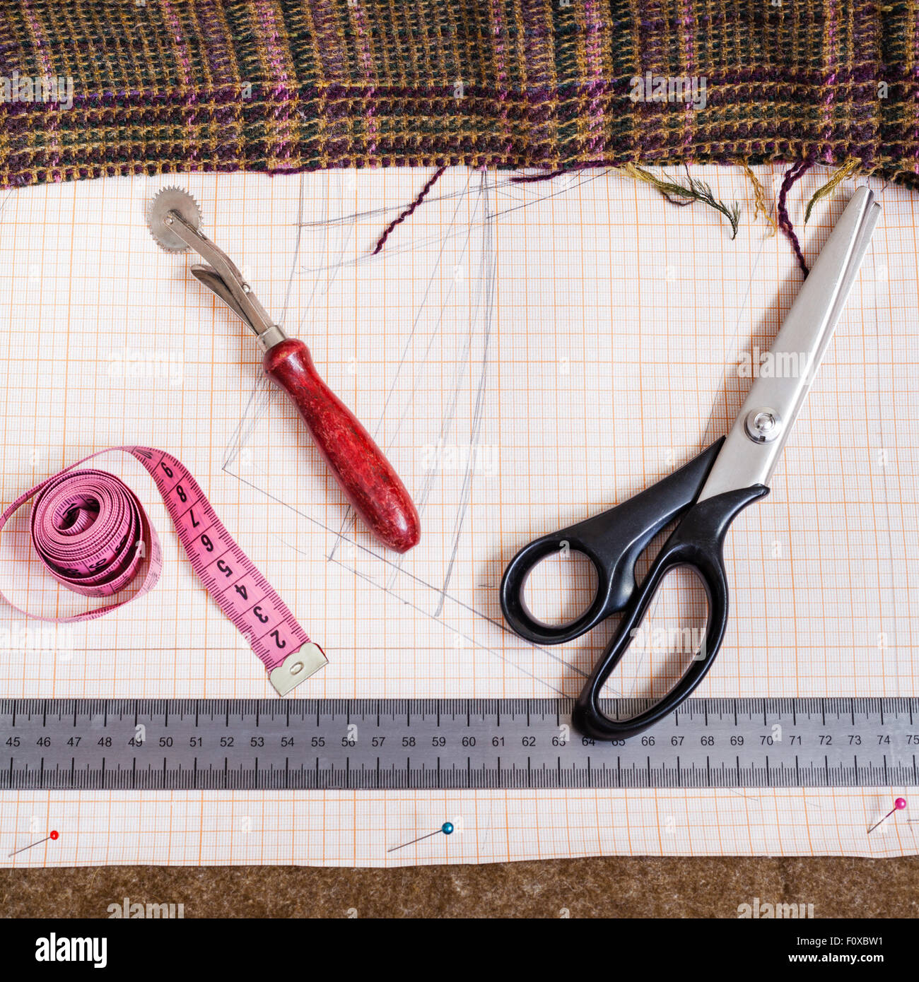 dressmaking still life - top view of cutting table with fabric, pattern ...