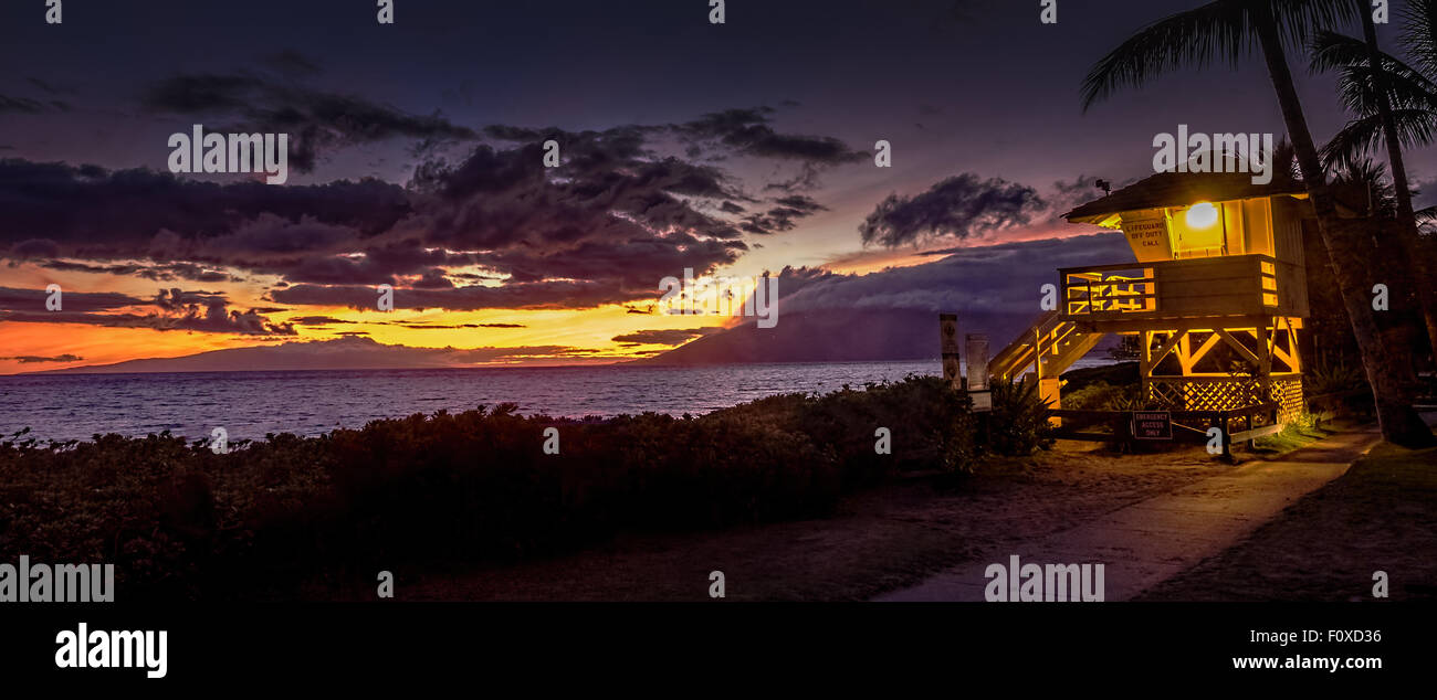 Kamaole Beach Park III at sunset with Lifeguards lookout lit up beneath ...