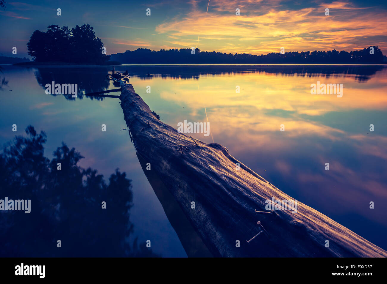 Vintage photo of beautiful sunset over calm lake. Landscape ...