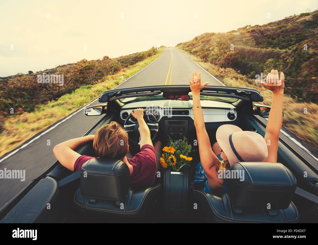 Happy Young Carefree Couple Driving Along Country Road in Convertible ...