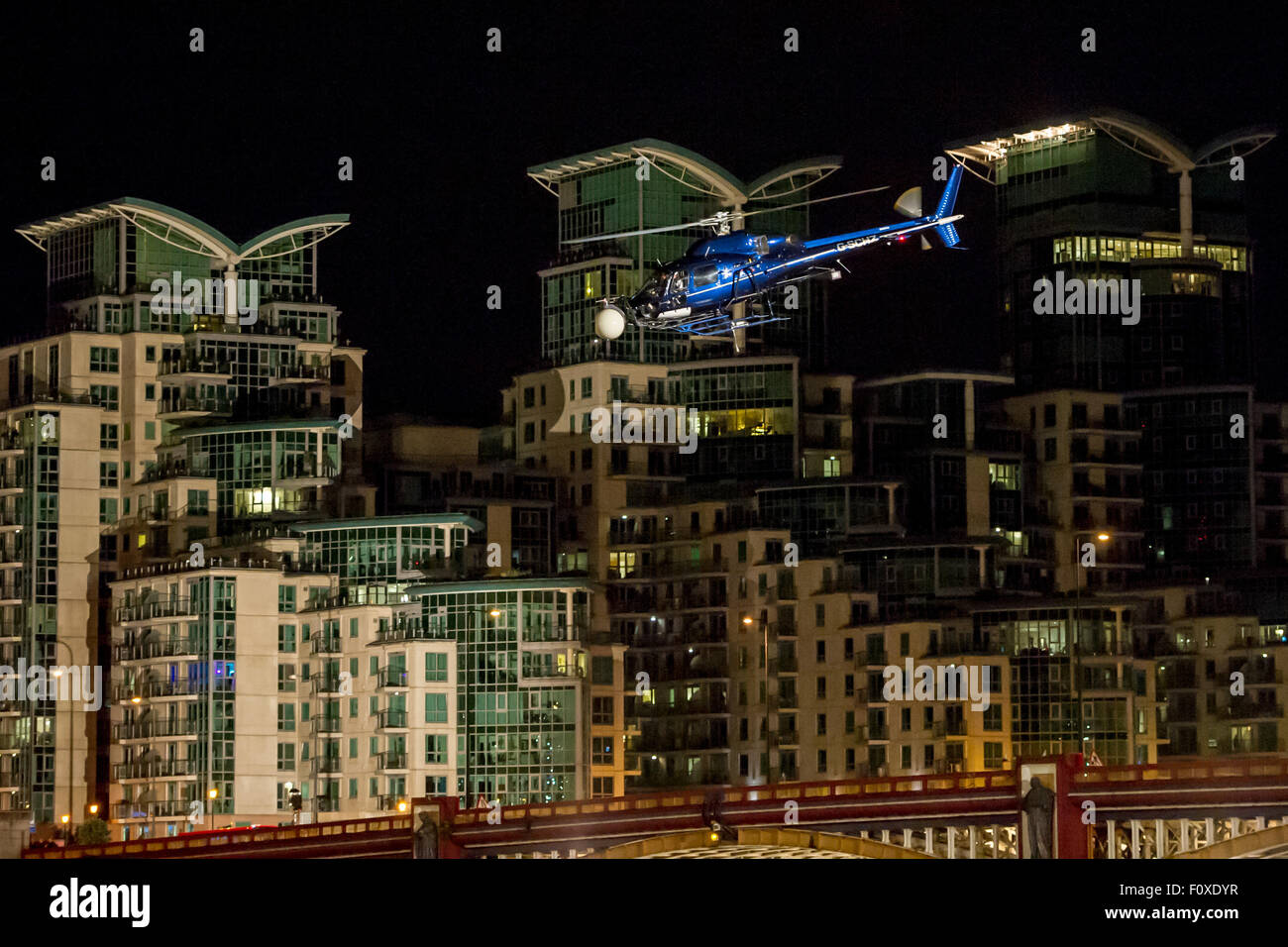 A helicopter flies over the River Thames as a boat containing body ...