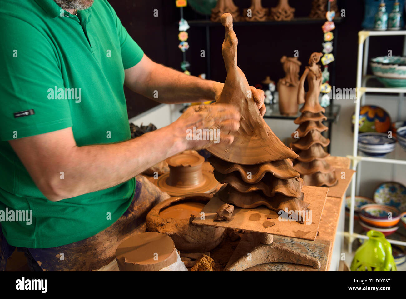 Sculptor modeling clay into a Flamenco dancer with dress in a Cordoba ...
