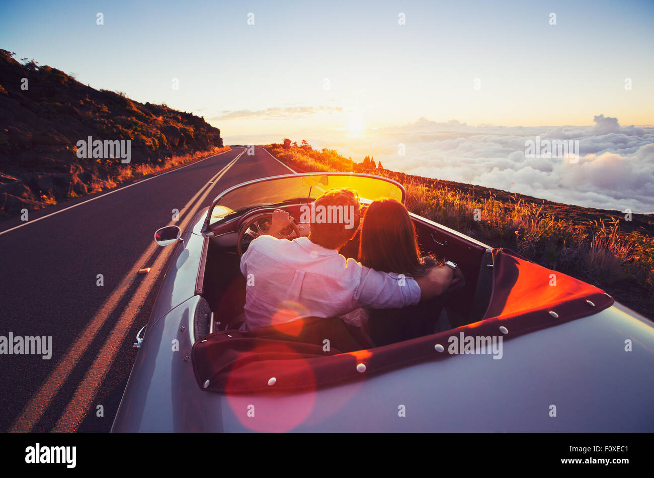 Driving into the Sunset. Romantic Young Couple Enjoying Sunset Drive in ...