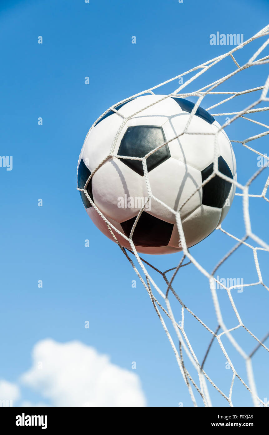 Soccer football in Goal net with the sky field Stock Photo - Alamy